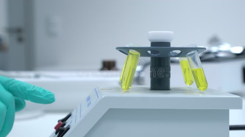 Lab Worker Places a Test Tube into the Microspin Device for ...
