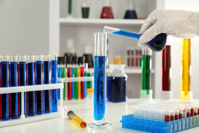 Lab Worker Pouring Blue Liquid into Test Tube on Table Stock Image ...