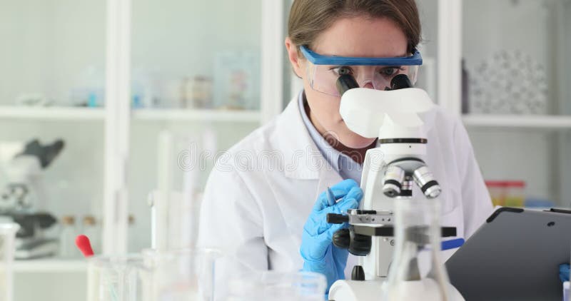 Lab Worker Studies Properties of Sample Under Microscope Stock Video ...