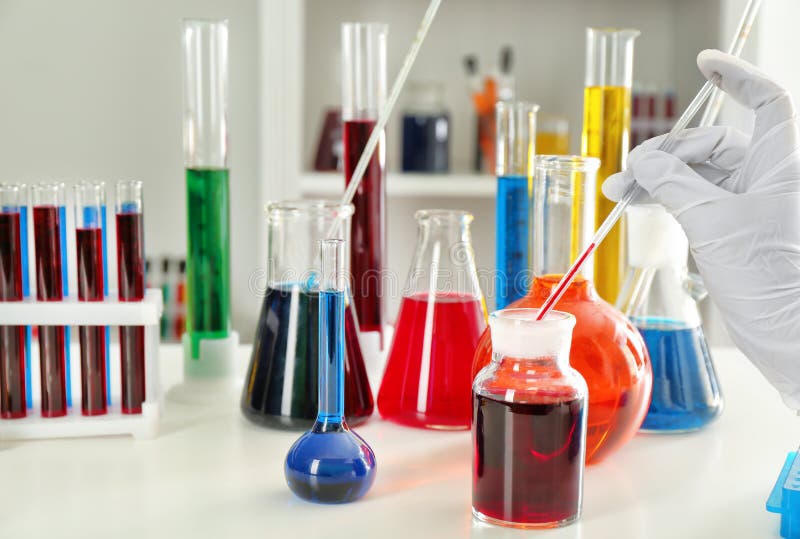 Lab Worker Taking Sample from Flask with Red Liquid on Table Stock ...