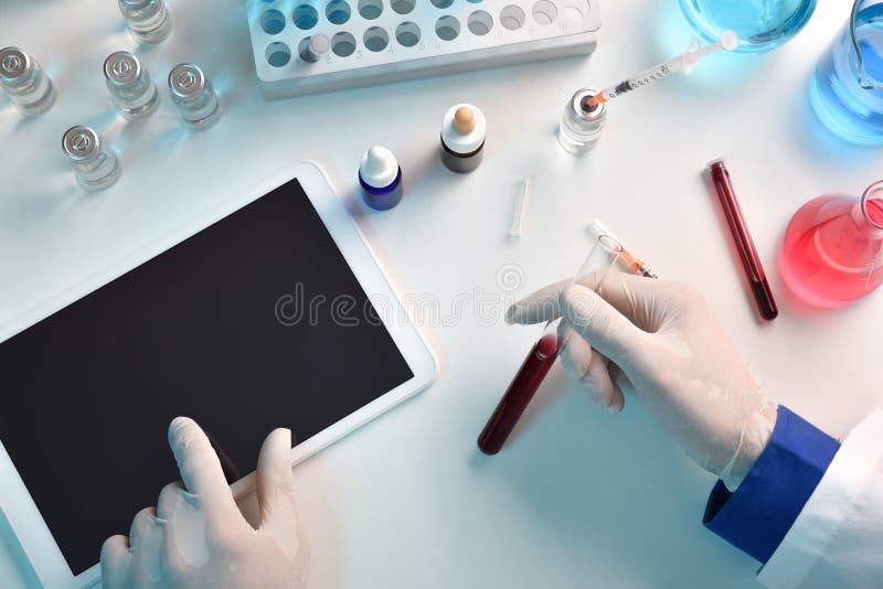 Lab Worker Using Tablet with Blood Sample in Laboratory Stock Photo ...