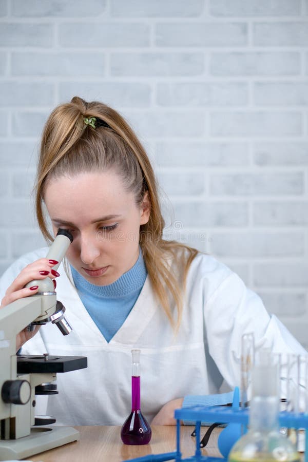 The Laboratory Assistant Examines Samples of Materials Under a ...