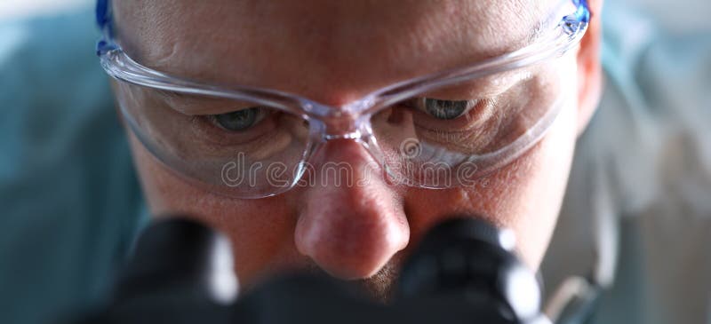 Laboratory Assistant Eyes Looking at Microscope Wearing Goggles Stock ...