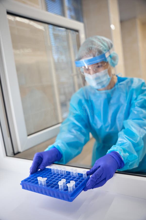 Laboratory Assistant in Protective Equipment Holds an Organizer Stock ...