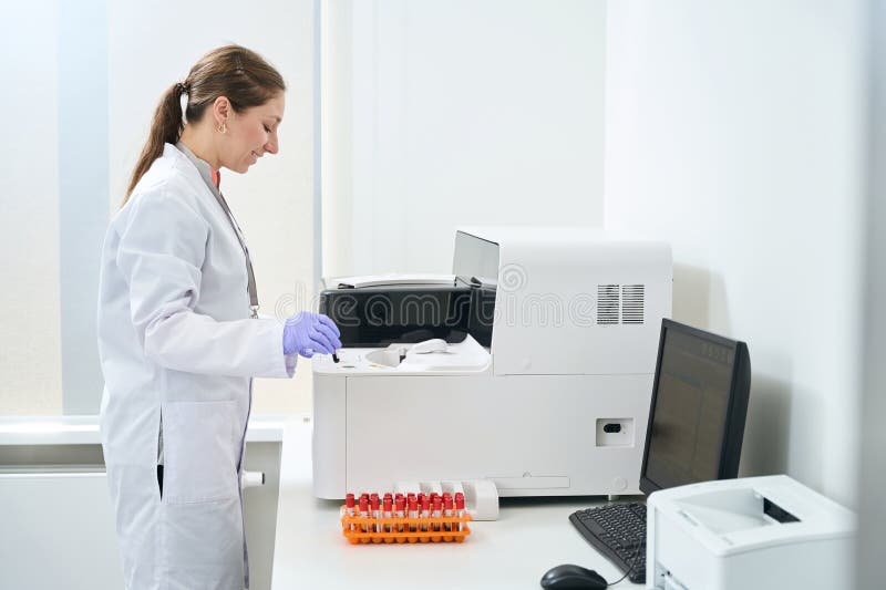 Laboratory Assistant Stands Near a Hematological Analyzer in Testing ...