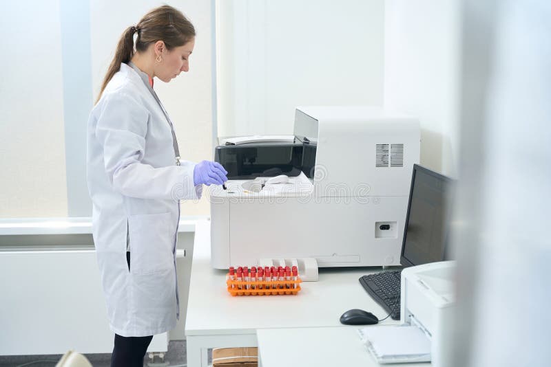 Laboratory Assistant Works with a Hematological Analyzer in Testing ...