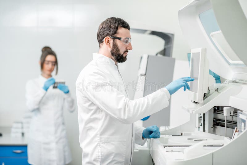 Laboratory Assistants Working with Analizer Stock Image - Image of male ...