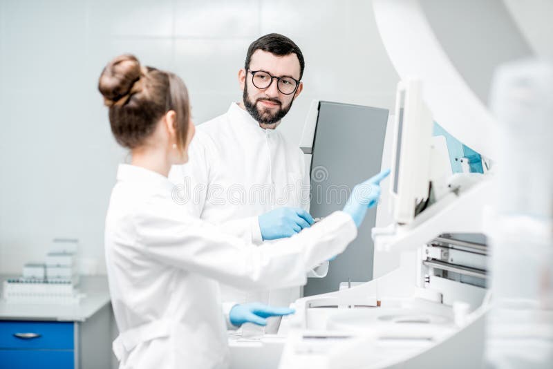 Laboratory Assistants Working with Analizer Stock Image - Image of ... Laboratory Assistants Working with Analizer Stock Image - Image of ...
