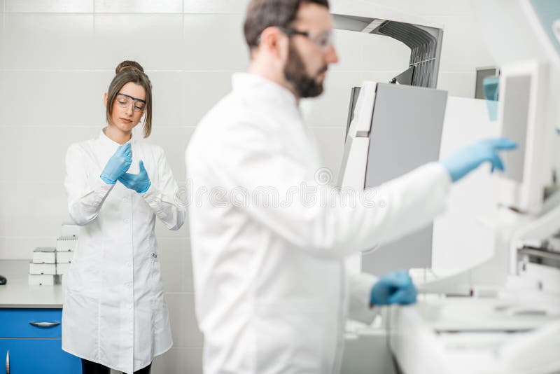 Laboratory Assistants Working with Analizer Stock Photo - Image of male ... Laboratory Assistants Working with Analizer Stock Photo - Image of male ...