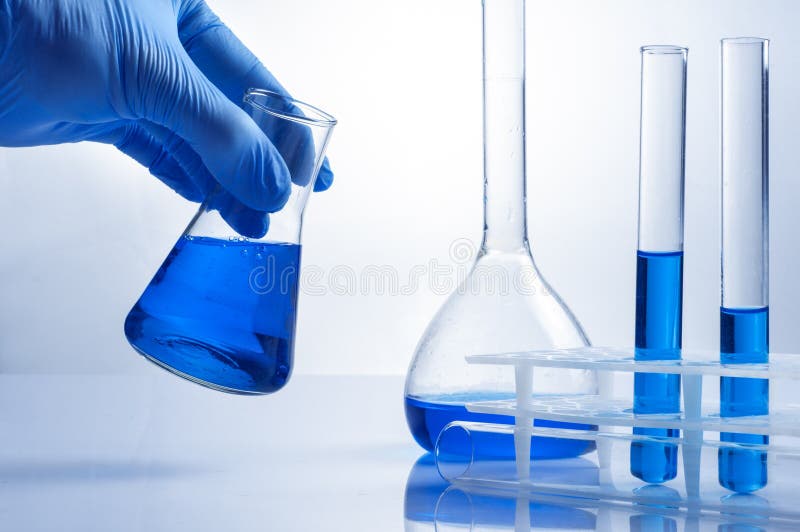 Laboratory Beaker in Analyst& X27;s Hand in Plastic Glove. Stock Image ...