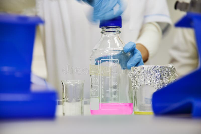 Laboratory Personnel Analyzing Red Liquid in Tube Stock Photo - Image ...