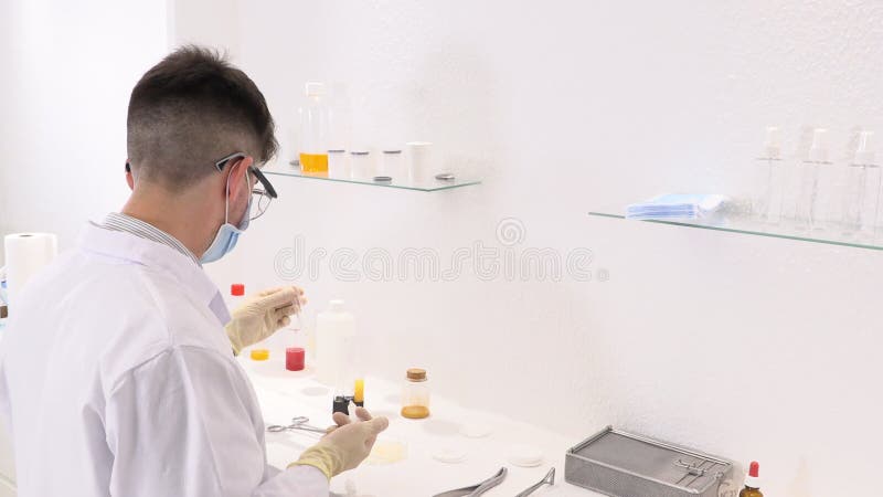 Laboratory Employee in a White Coat at the Workplace Stock Video ...