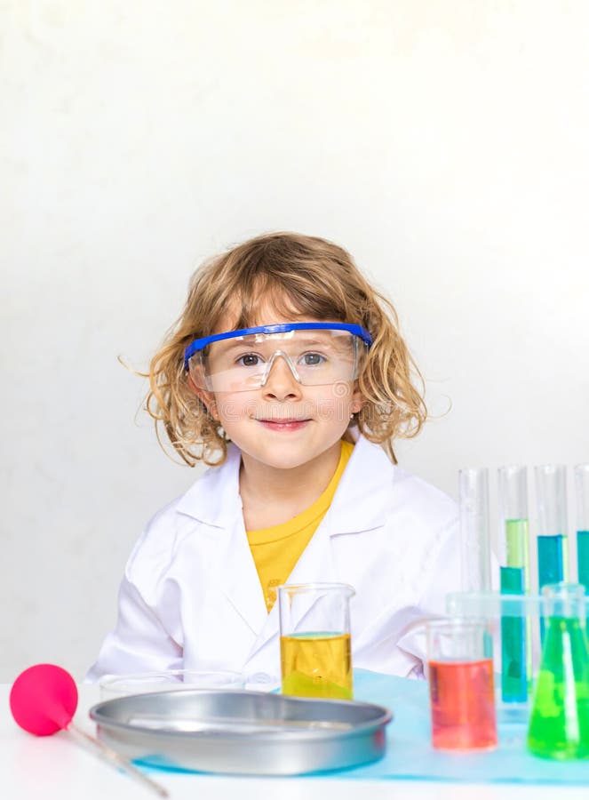 Laboratory Examination of a Child with Test Tubes, Reagents and a ...