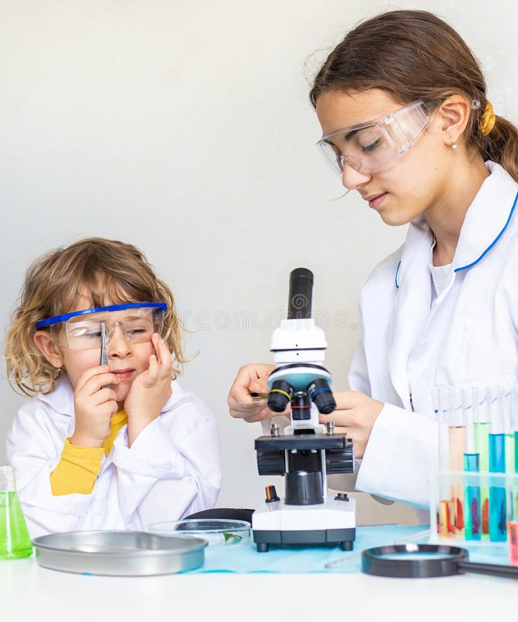 Laboratory Examination of a Child with Test Tubes, Reagents and a ...