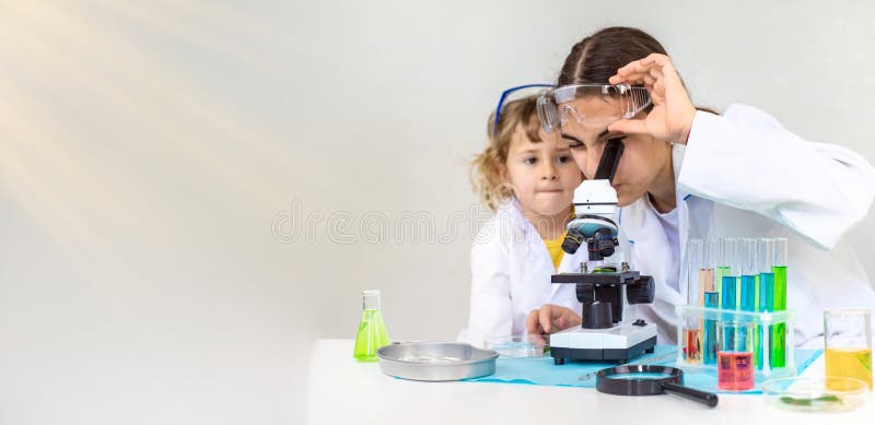 Laboratory Examination of a Child with Test Tubes, Reagents and a ...