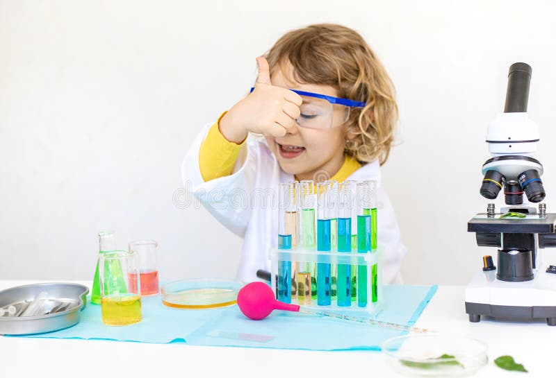 Laboratory Examination of a Child with Test Tubes, Reagents and a ...