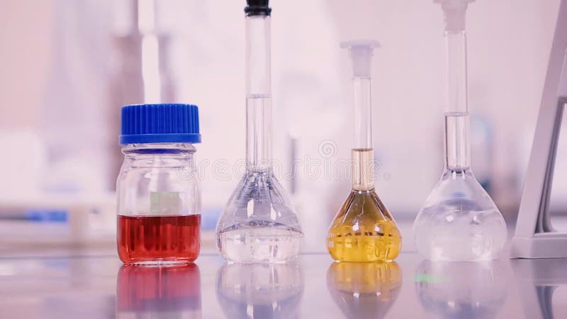 Laboratory Flasks and Beakers with Liquids of Different Colors on Lab ...