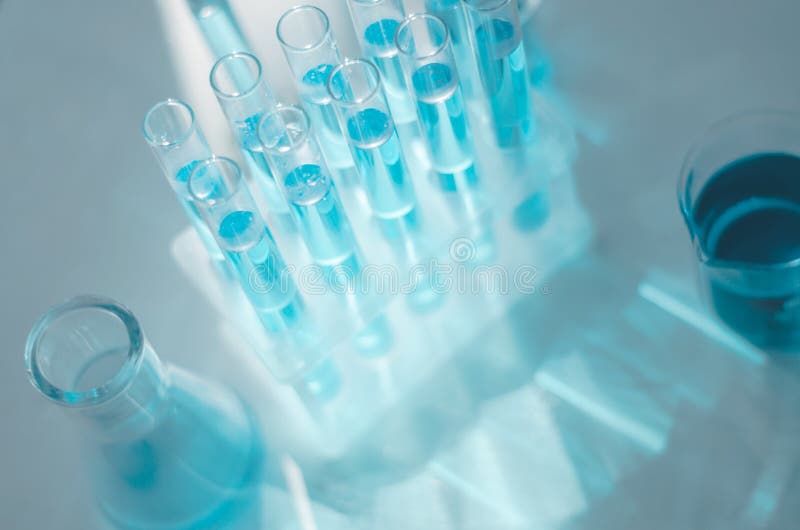 Laboratory Flasks and Test Tubes on the Table in the Rays of Sunlight ...