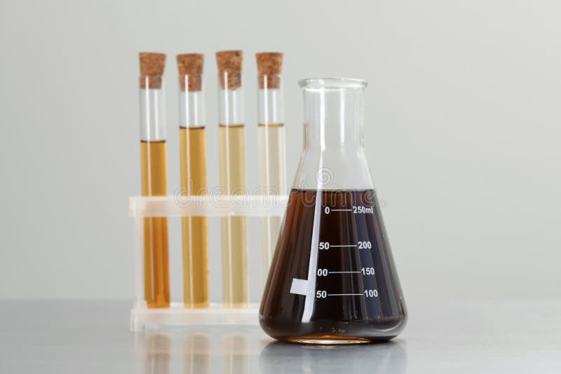 Laboratory Glassware with Brown Liquids on Light Background Stock Photo ...