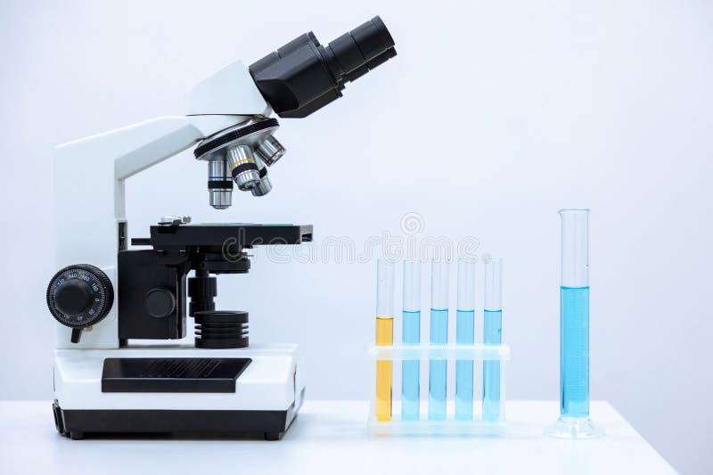 Laboratory Glassware with Color Liquid and Microscope, Microbiologist ...