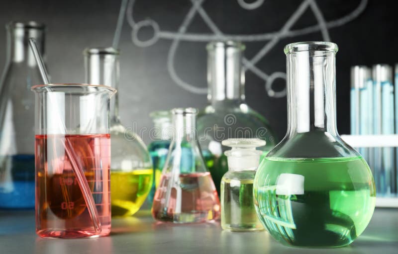 Laboratory Glassware on Table Near Chalkboard Stock Photo - Image of ...