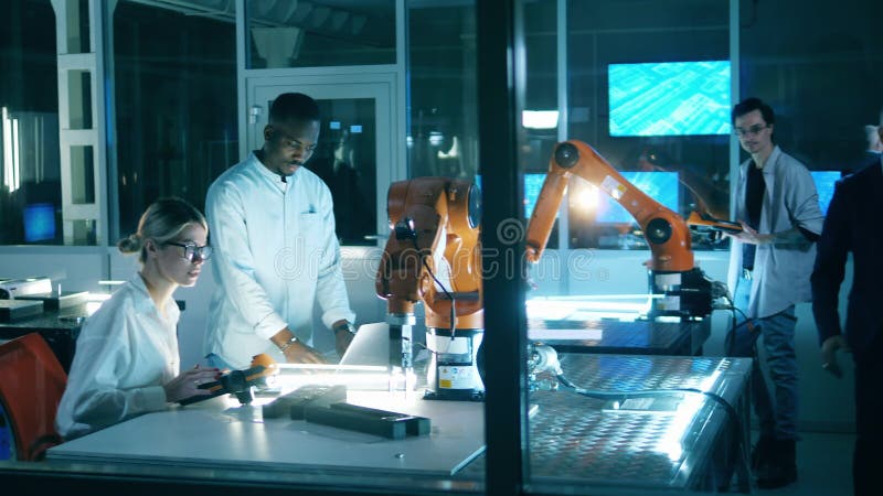 It Laboratory with a Group of Engineers Studying Robots Stock Footage ...