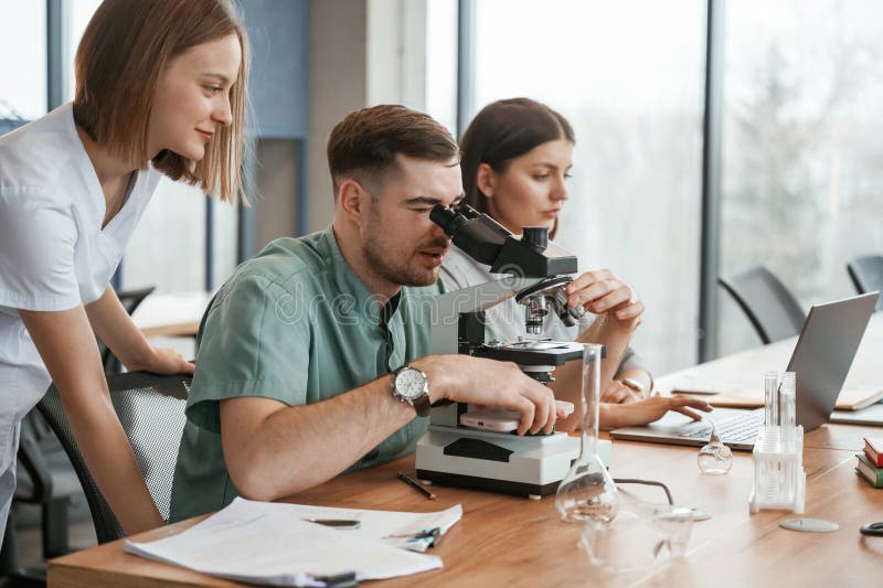 Laboratory with Microscope. Group of Doctors are Together Indoors Stock ...