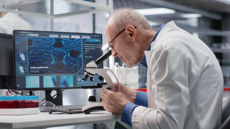 Laboratory with Old Male Scientist Observing Specimen Under Microscope ...