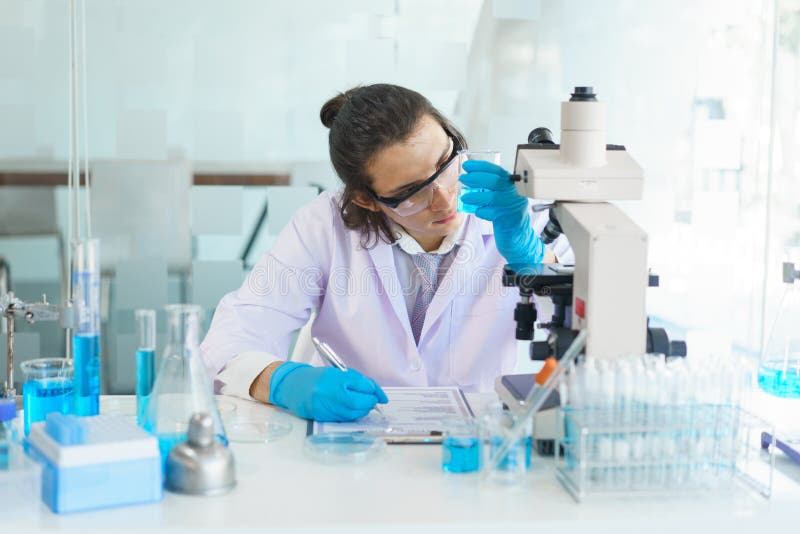 Laboratory Research Concept, Scientist Analyzing Sample in Beaker and ...