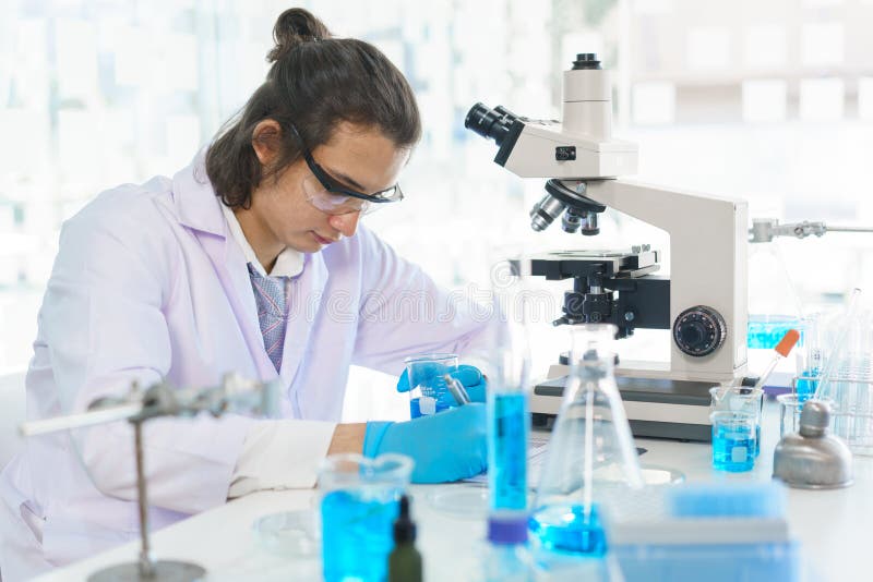 Laboratory Research Concept, Scientist Working in Lab and Writing ...