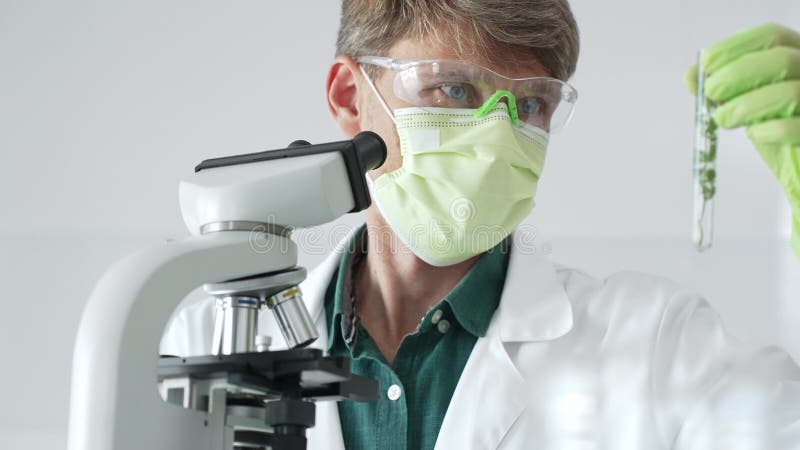 Laboratory Scientist Analyzing Medical Sample, Wearing Green Protective ...