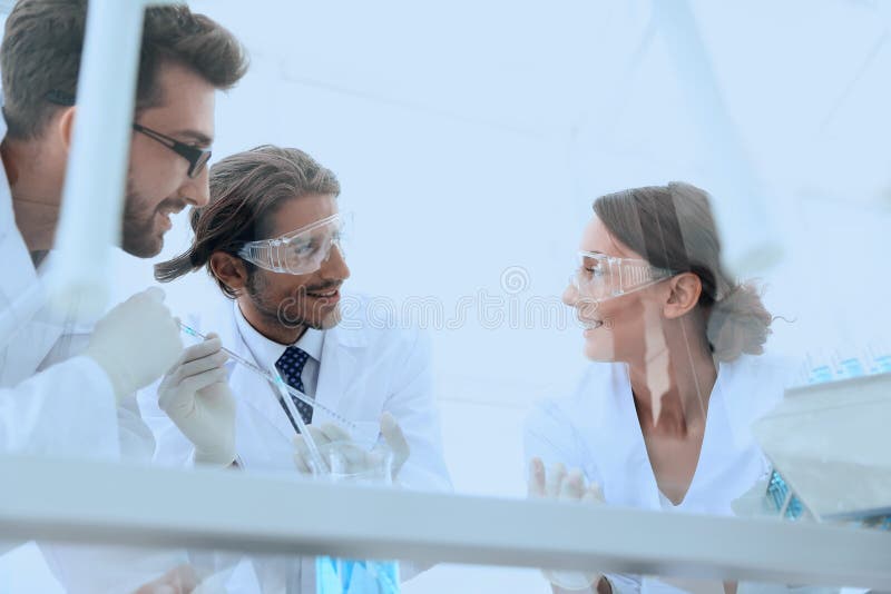Group of Scientists Working on an Experiment at the Laboratory Stock ...