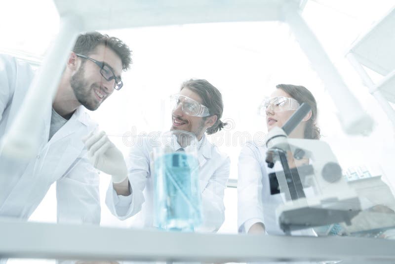 Group of Scientists Working on an Experiment at the Laboratory Stock ...