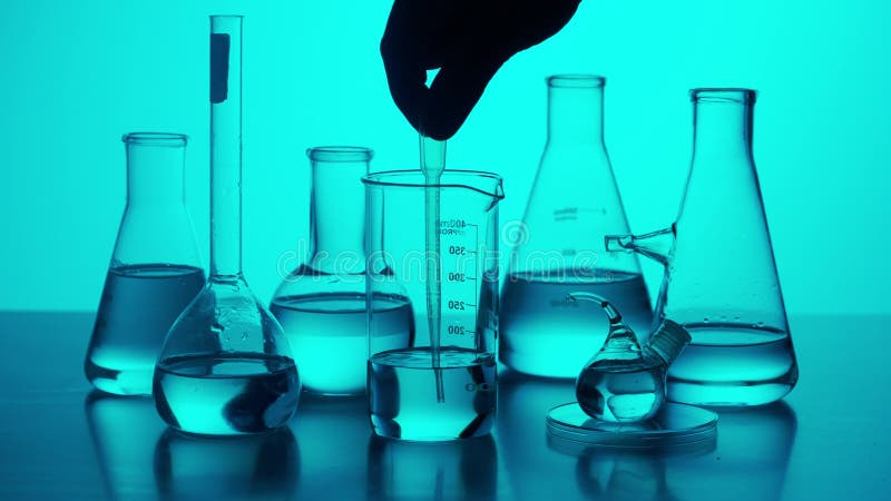 Laboratory Table with Many Different Beakers and Flasks, Scientist ...