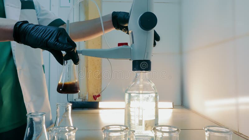 Laboratory Technician Adjusting Flask, Scientist Adjusting a Flask with ...