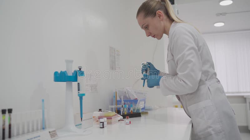 Laboratory Technician with Dispenser in during Blood Testing. Medical ...