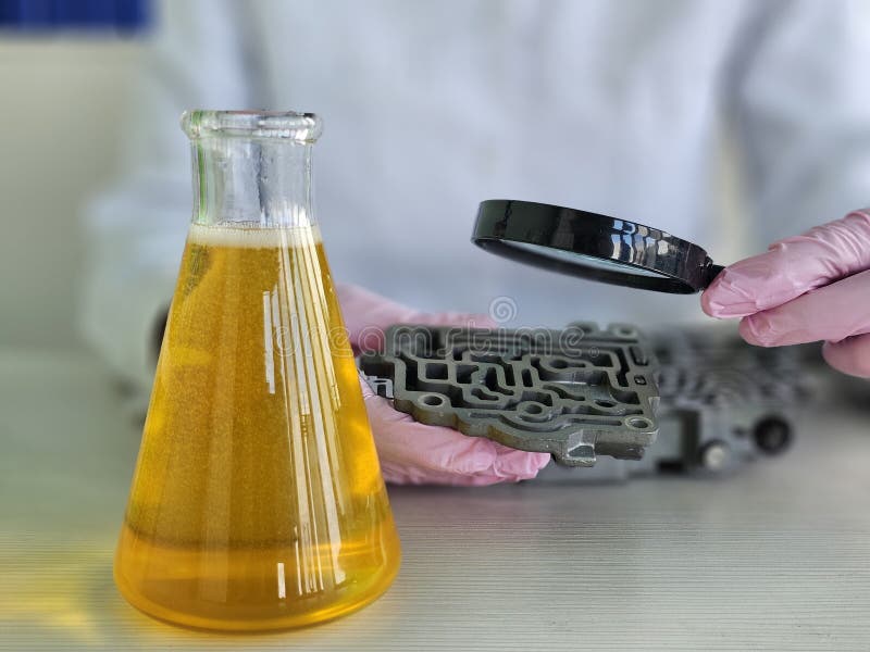 Laboratory Technician Examines Fluid Sample Using a Magnifying Glass ...