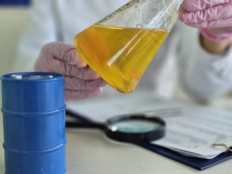 Laboratory Technician Examines Fluid Sample Using a Magnifying Glass ...