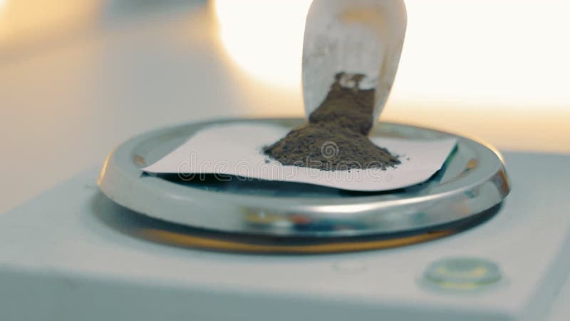 A Laboratory Technician Measures the Weight of a Sample of the Finished ...