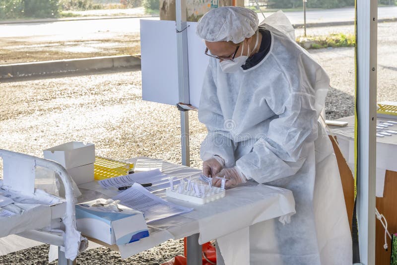 A Laboratory Technician Performs a Rapid Covid-19 Test with a Device ...