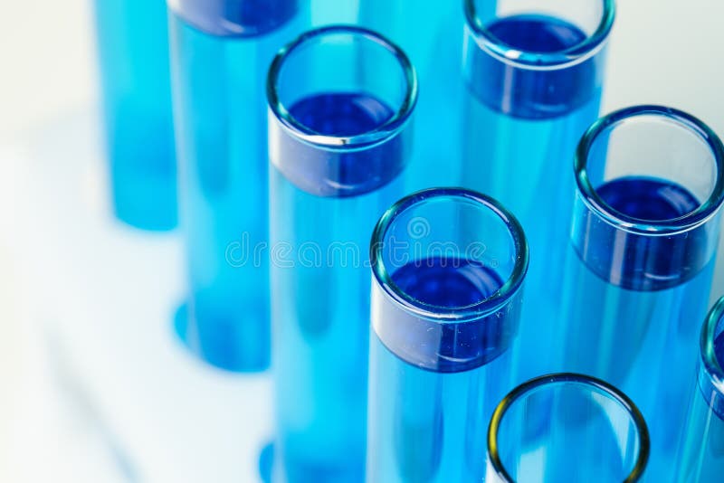 Close Up of Laboratory Microscope with Set of Test Tubes with Blue ...