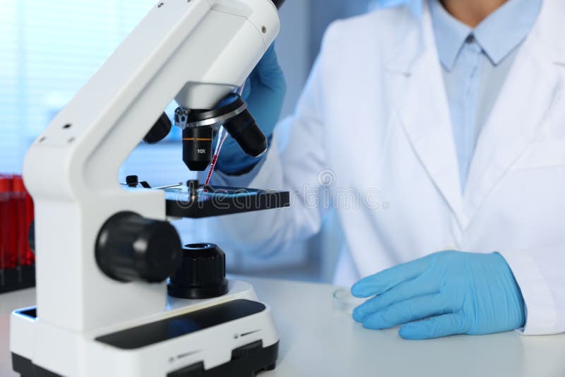 Laboratory Testing. Doctor Dripping Blood Sample Onto Glass Slide while ...