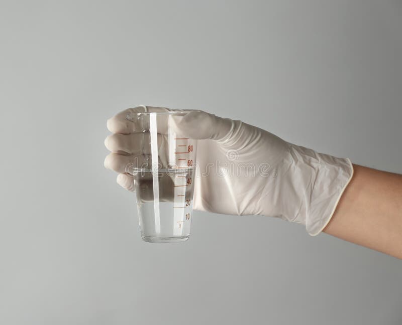Laboratory Worker Holding Beaker with Water on Grey Background Stock ...