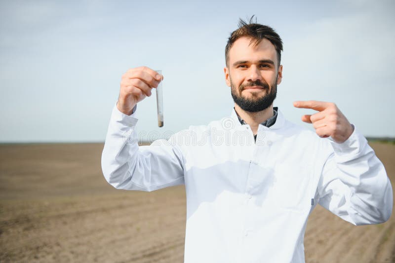 Laboratory Worker Holding Professional Glassware and Testing Black Soil ...