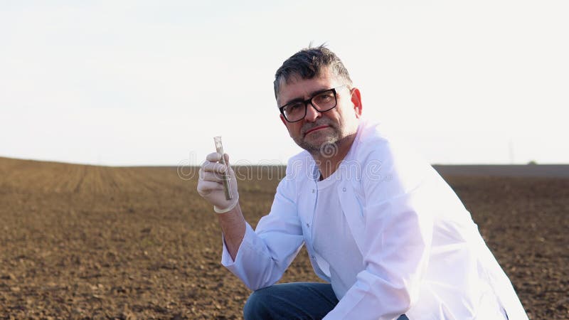 Senior Scientist Studying Sample of Soil in Field. Soil Sampling for ...