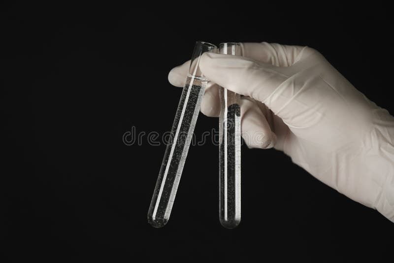 Laboratory Worker Holding Test Tubes with Water on Black Background ...