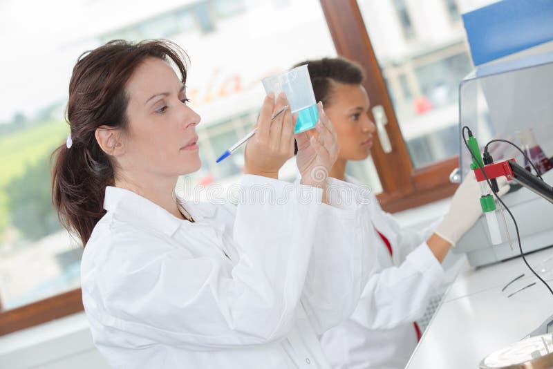 Laboratory Worker Measuring Liquid in Beaker Stock Photo - Image of ...