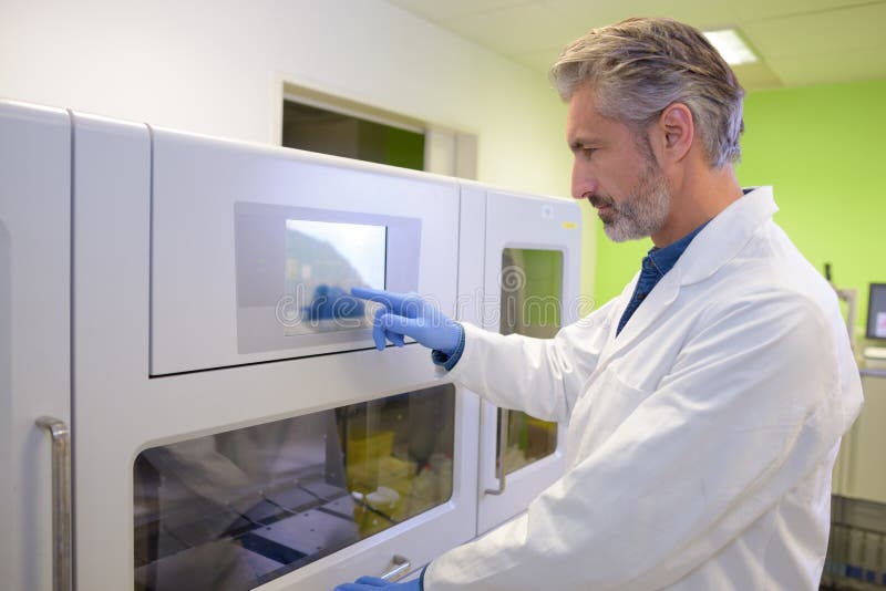 Laboratory Worker Pointing Inside Machine Stock Image - Image of ...