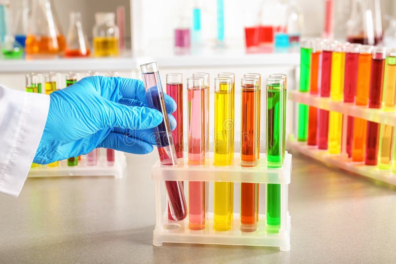 Laboratory Worker Taking Test Tube with Color Sample from Holder ...
