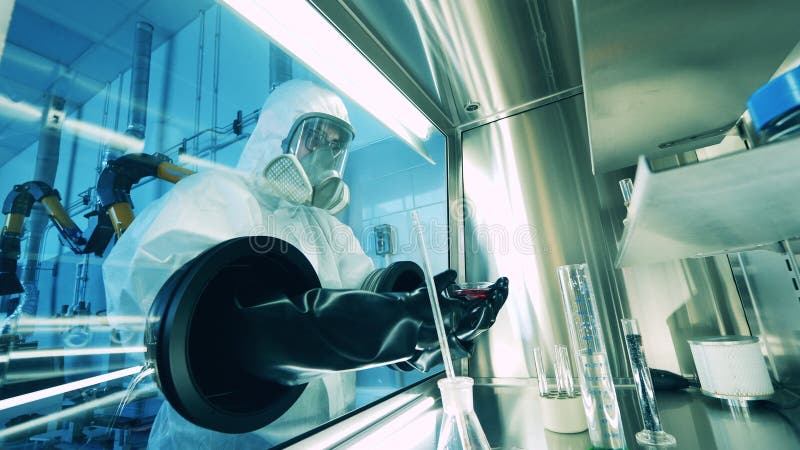 Laboratory Worker is Using a Vacuum Cabinet for Research of Probes ...